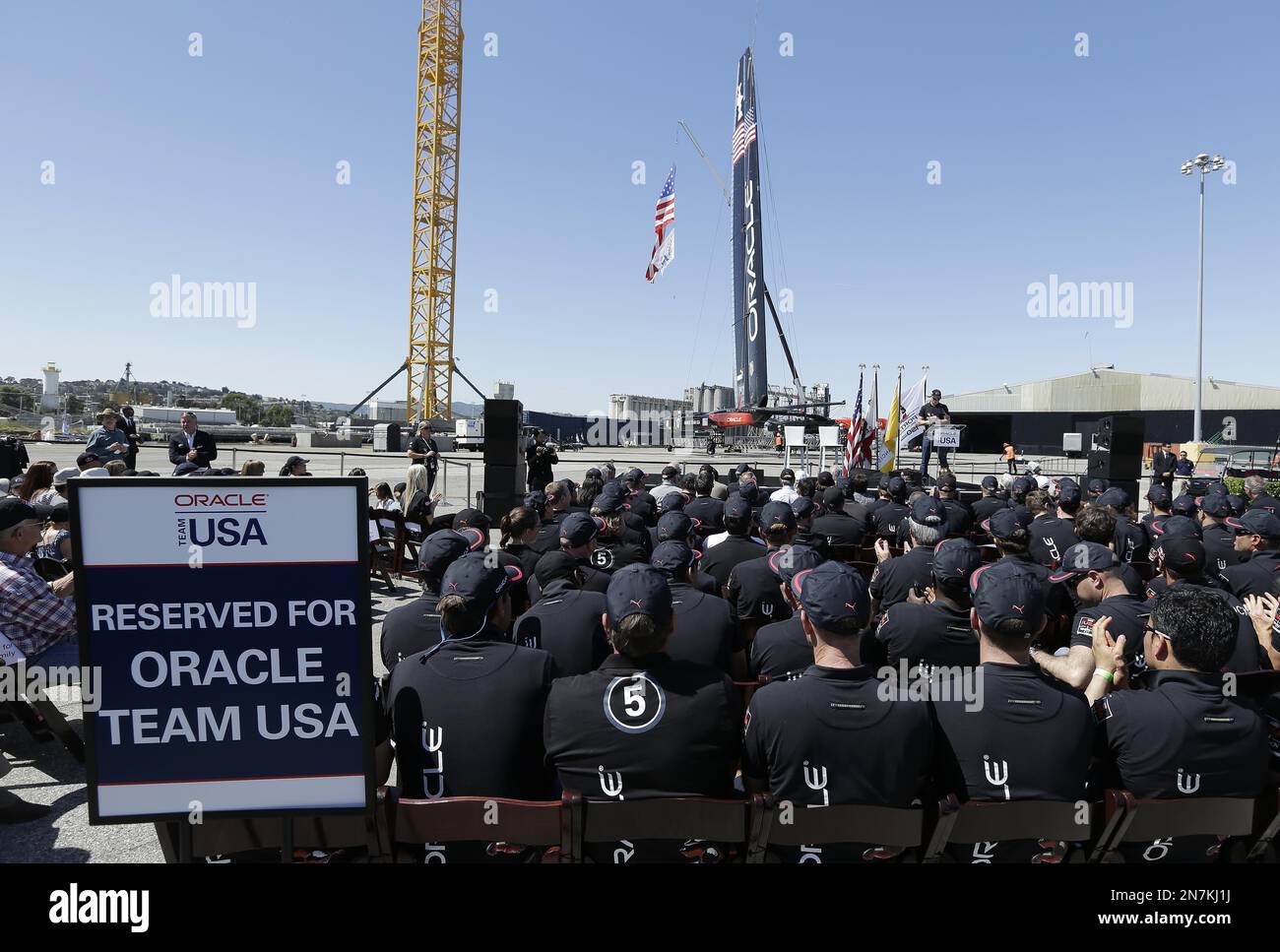 Oracle Team USA members watch the ceremonies before their newest AC72 ...