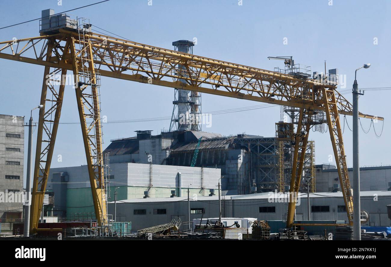 A chimney stands over the damaged reactor at the Chernobyl nuclear ...
