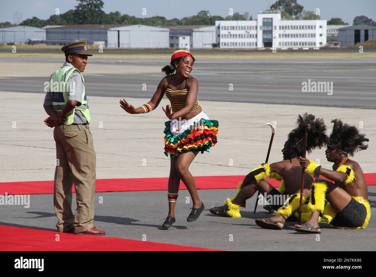 A traditional dancer performs while waiting for the arrival of Malawian ...