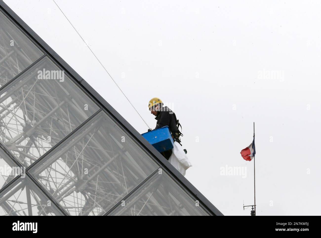 A window cleaner works on the glass-pyramid of the Louvre museum in ...