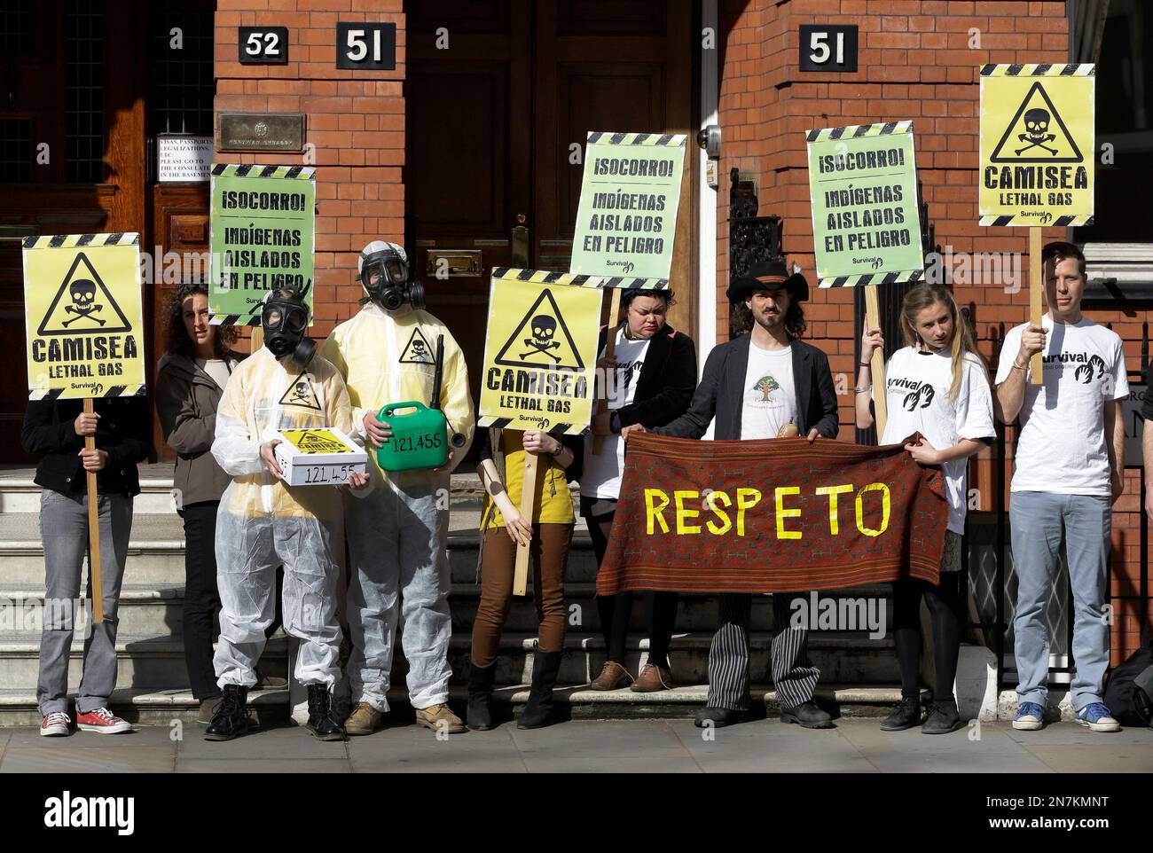 Environmental activists, some wearing gas masks and holding placards ...