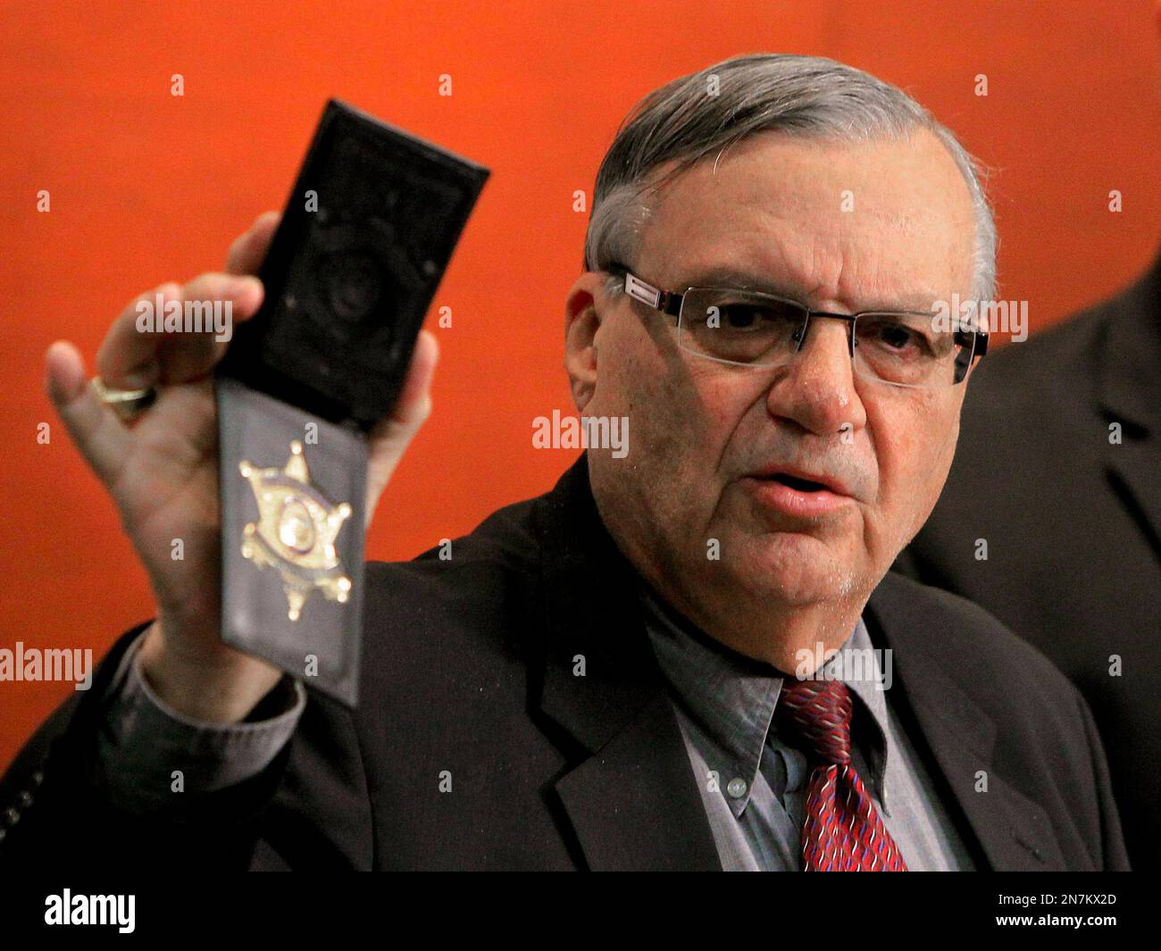 Maricopa County Sheriff Joe Arpaio shows his badge as he holds a ...