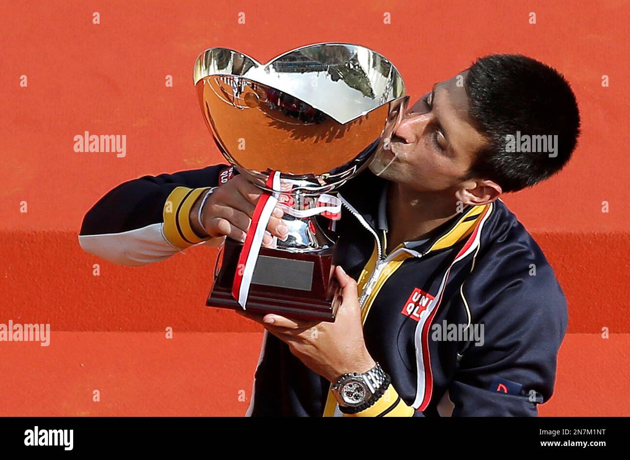Novak Djokovic of Serbia kisses his cup after defeating Spain's Rafael ...