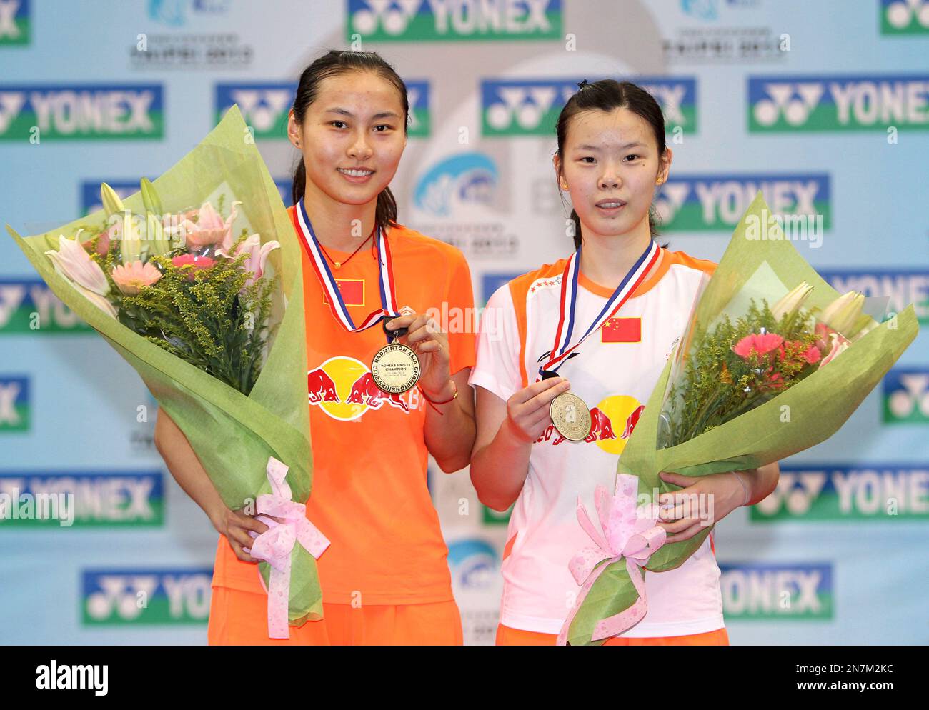 China's Wang Yihan, left, and Li Xuerui show off their gold and silver ...