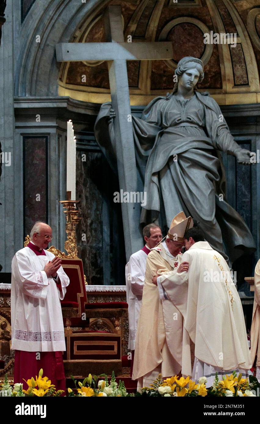 Pope Francis hugs a newly ordained priest during a ceremony in St ...