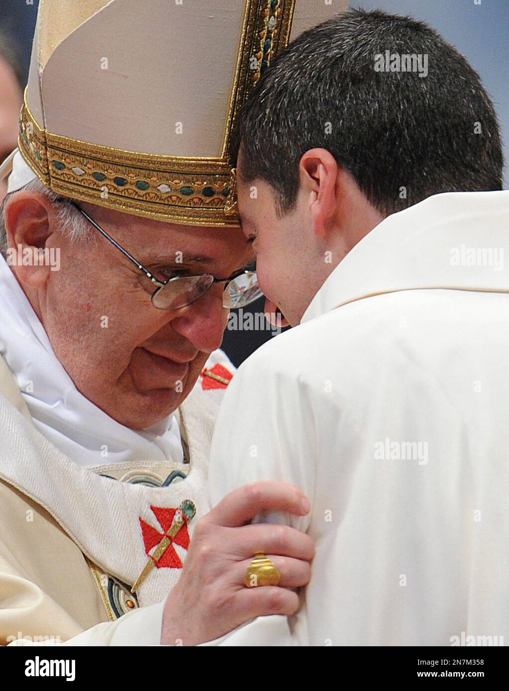 Pope Francis hugs a newly ordained priest during a ceremony in St ...