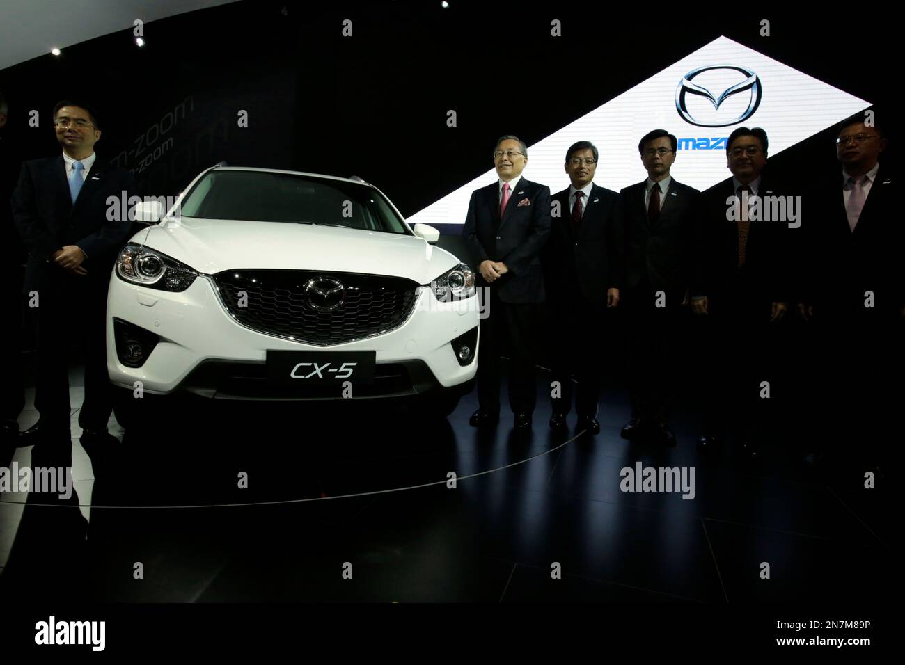 Mazda Motor Co. President and CEO Takashi Yamanouchi, fifth from right ...