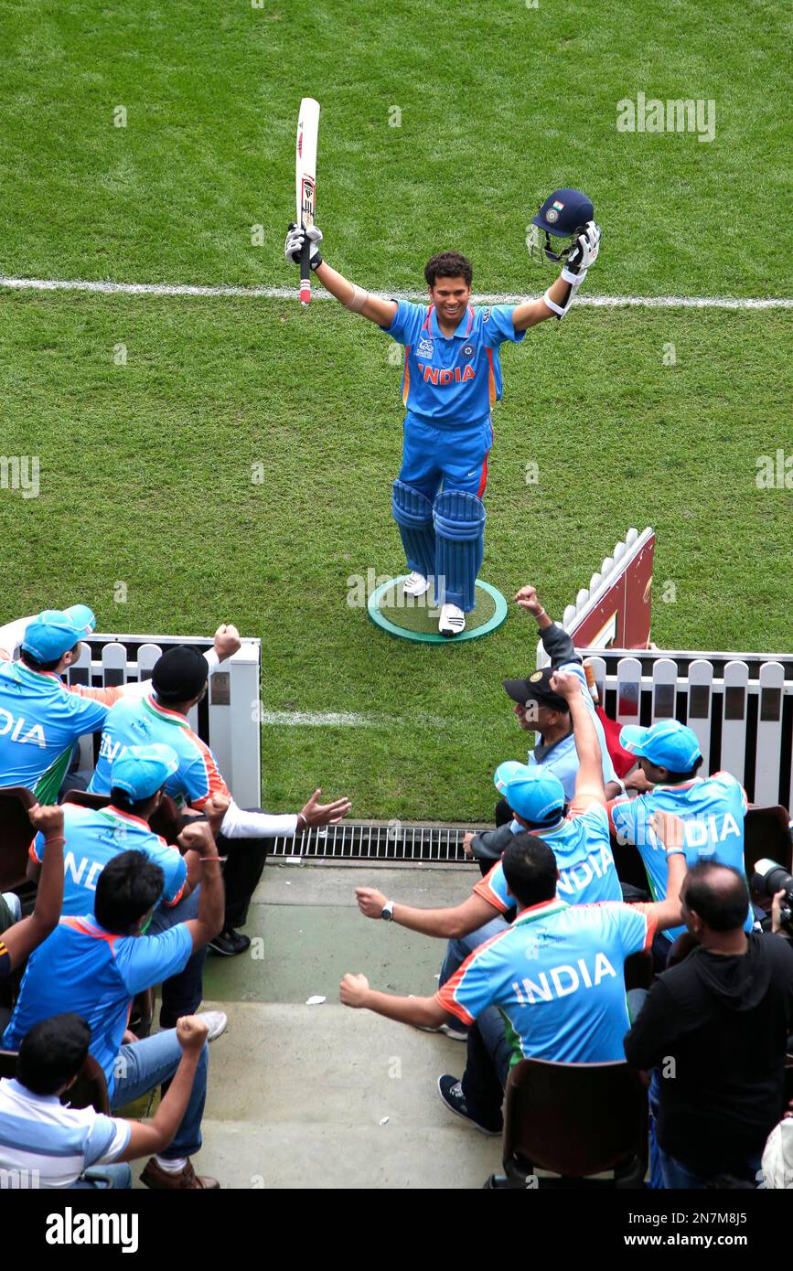 Indian cricket fans pretend to cheer for a wax statue of Indian ...