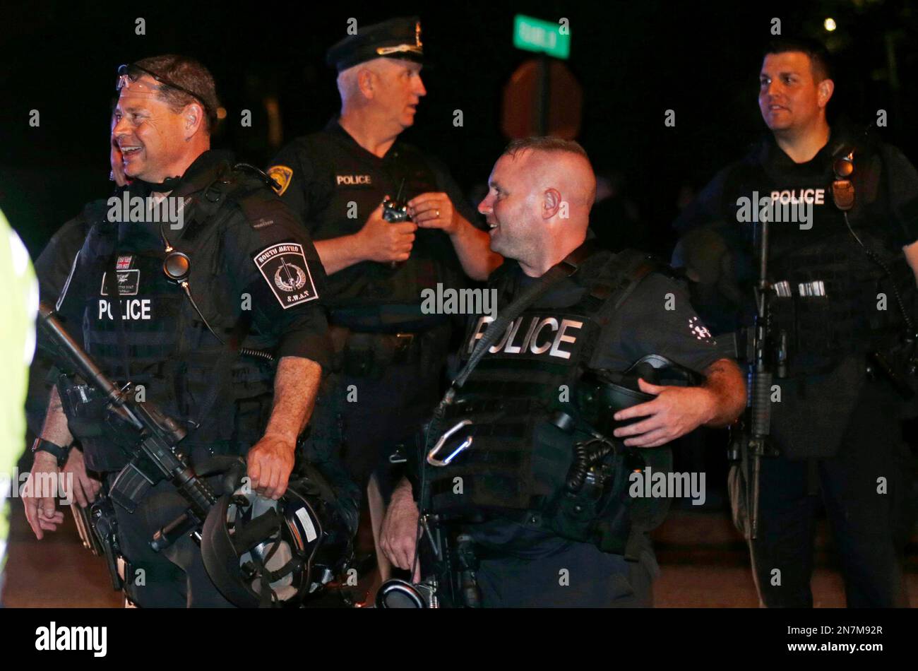 Police SWAT team member smile as they leave the scene of the arrest of ...