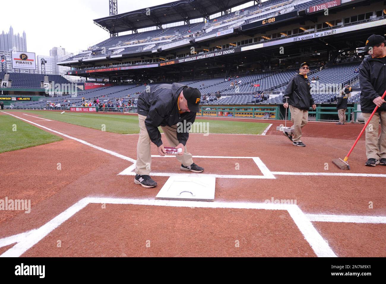 Pittsburgh Pirate ground crew gets home plate ready before a MLB game ...