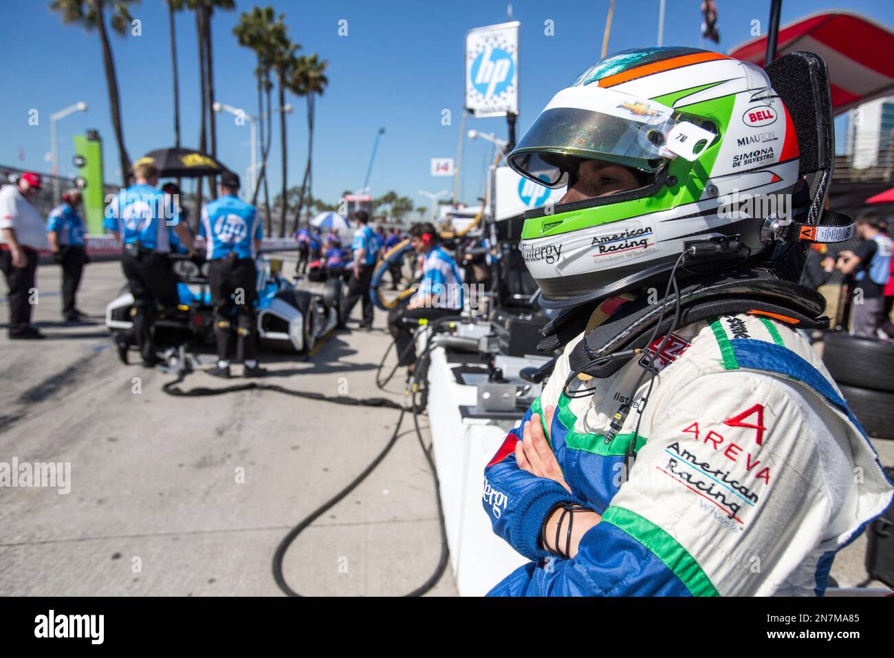 Driver Simona de Silvestro, of Switzerland, sits on a pit road wall ...