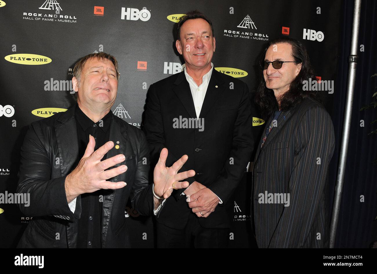 From left, Alex Lifeson, Neil Peart, and Geddy Lee of Rush attend the ...