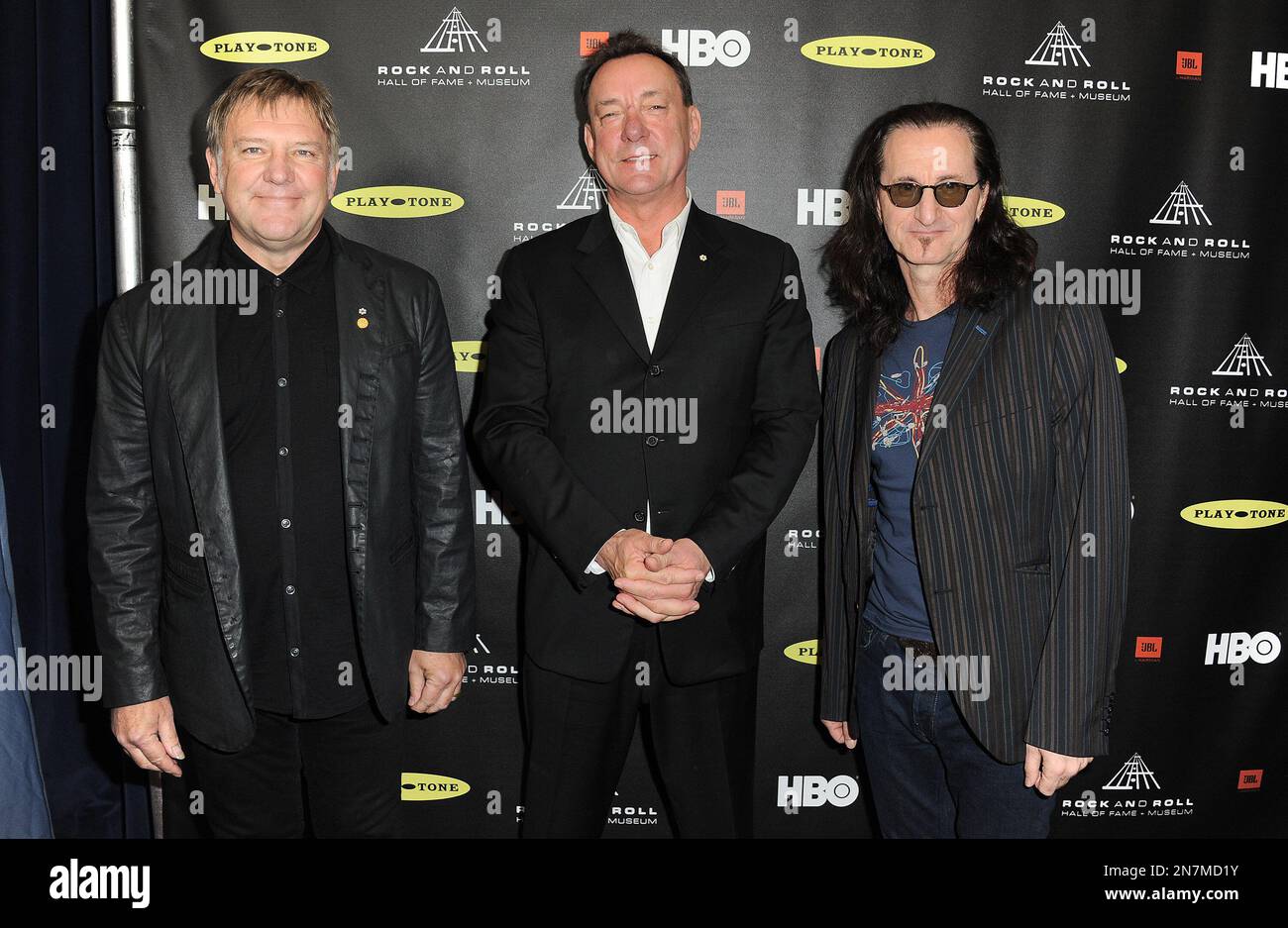 From left, Alex Lifeson, Neil Peart, and Geddy Lee of Rush attend the ...