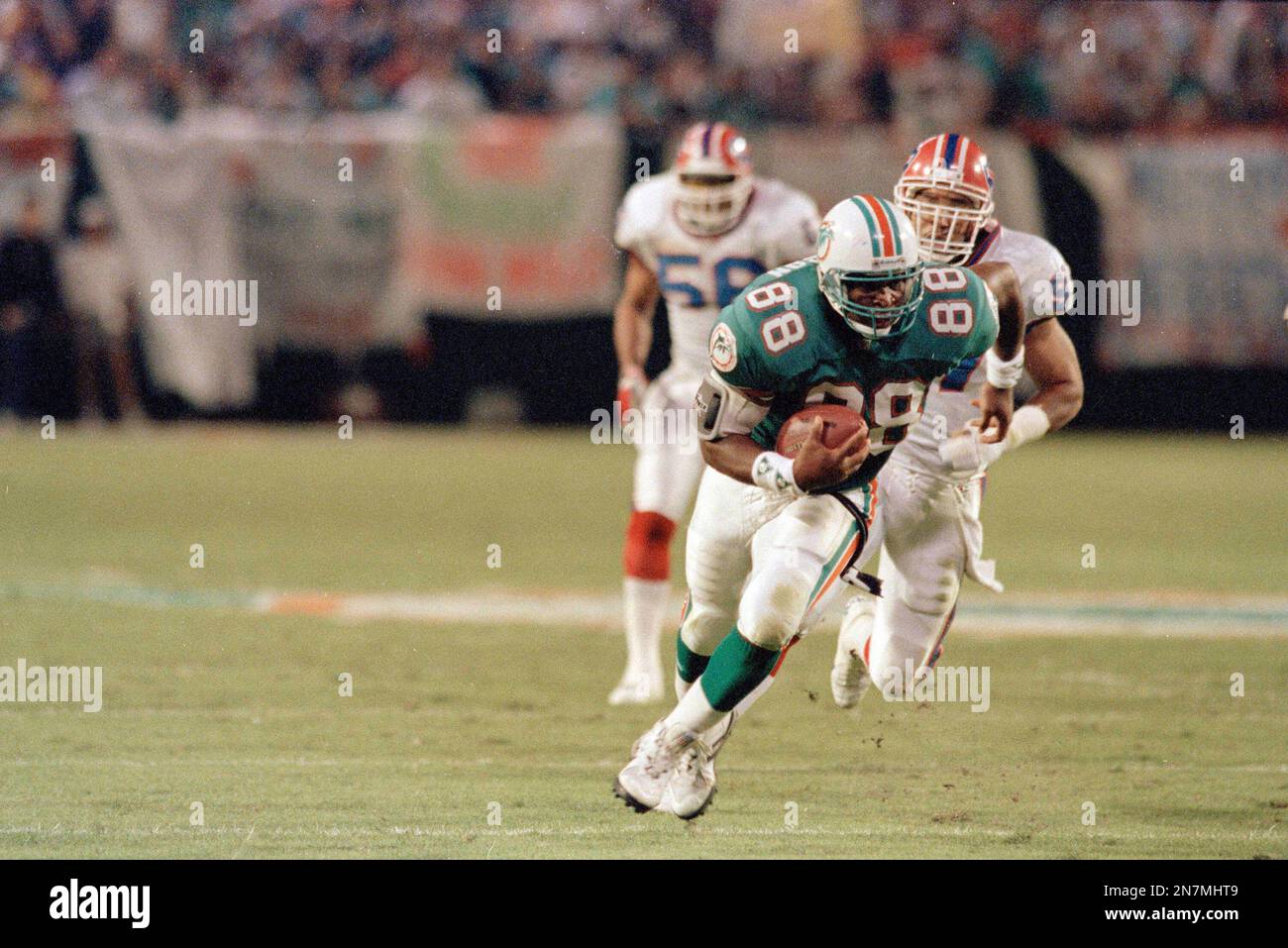 Miami Dolphin tight end Keith Jackson (88) gets yardage after catching ...