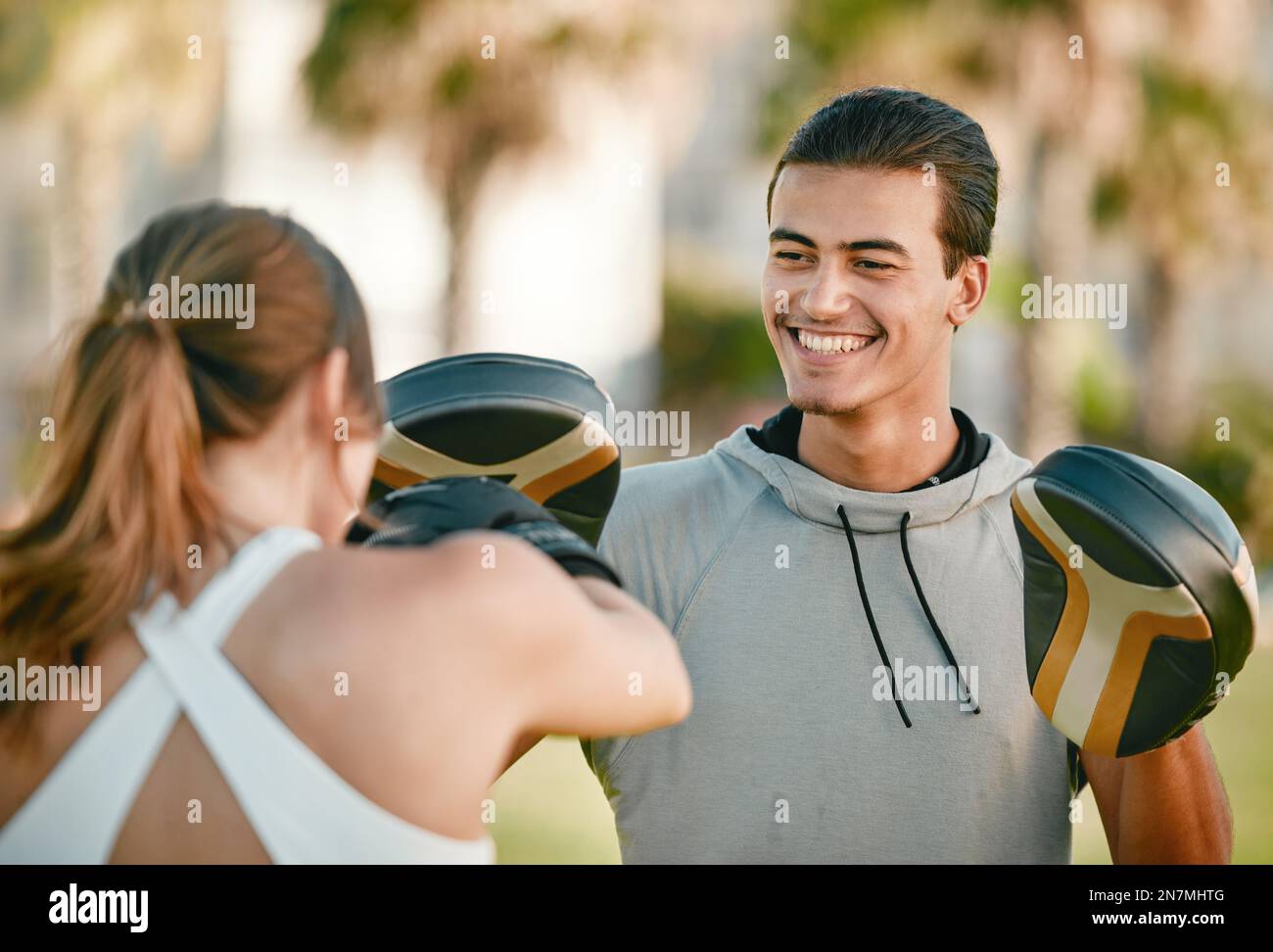 Man, personal trainer and boxing exercise outdoor in nature park for ...