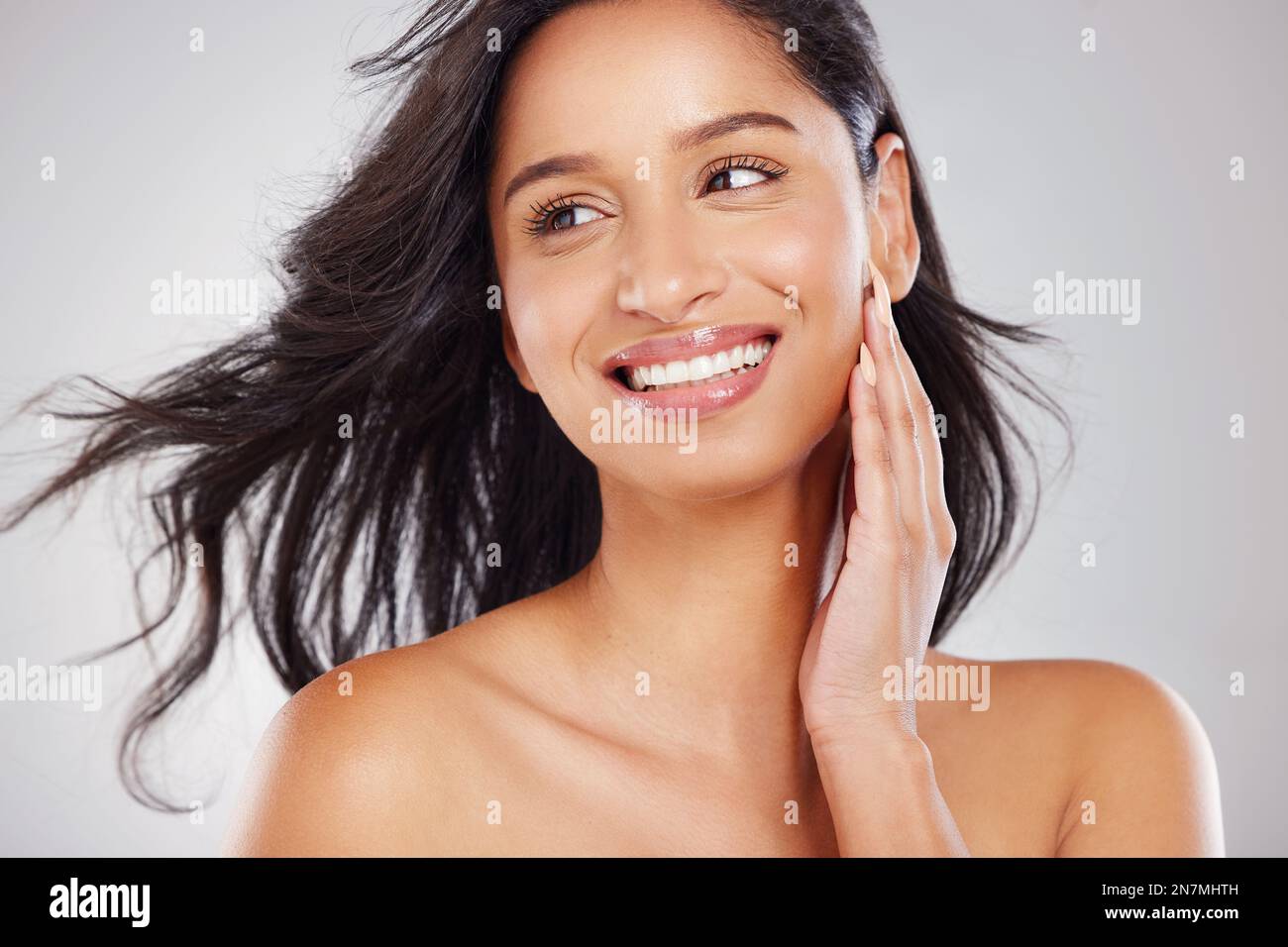 See how bright my skin is glowing. an attractive young woman posing in ...