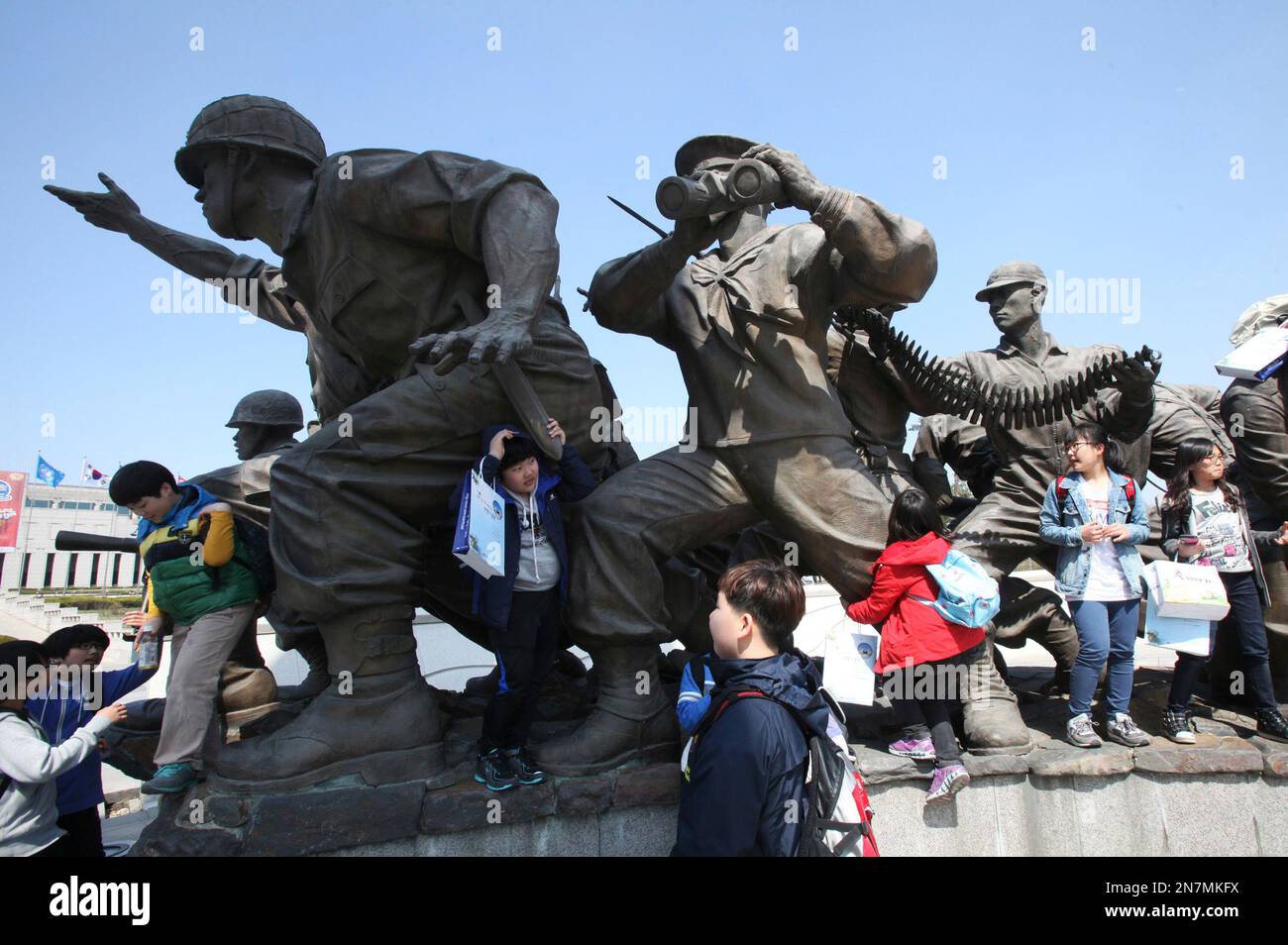 South Korean elementary school students play around the statues of ...