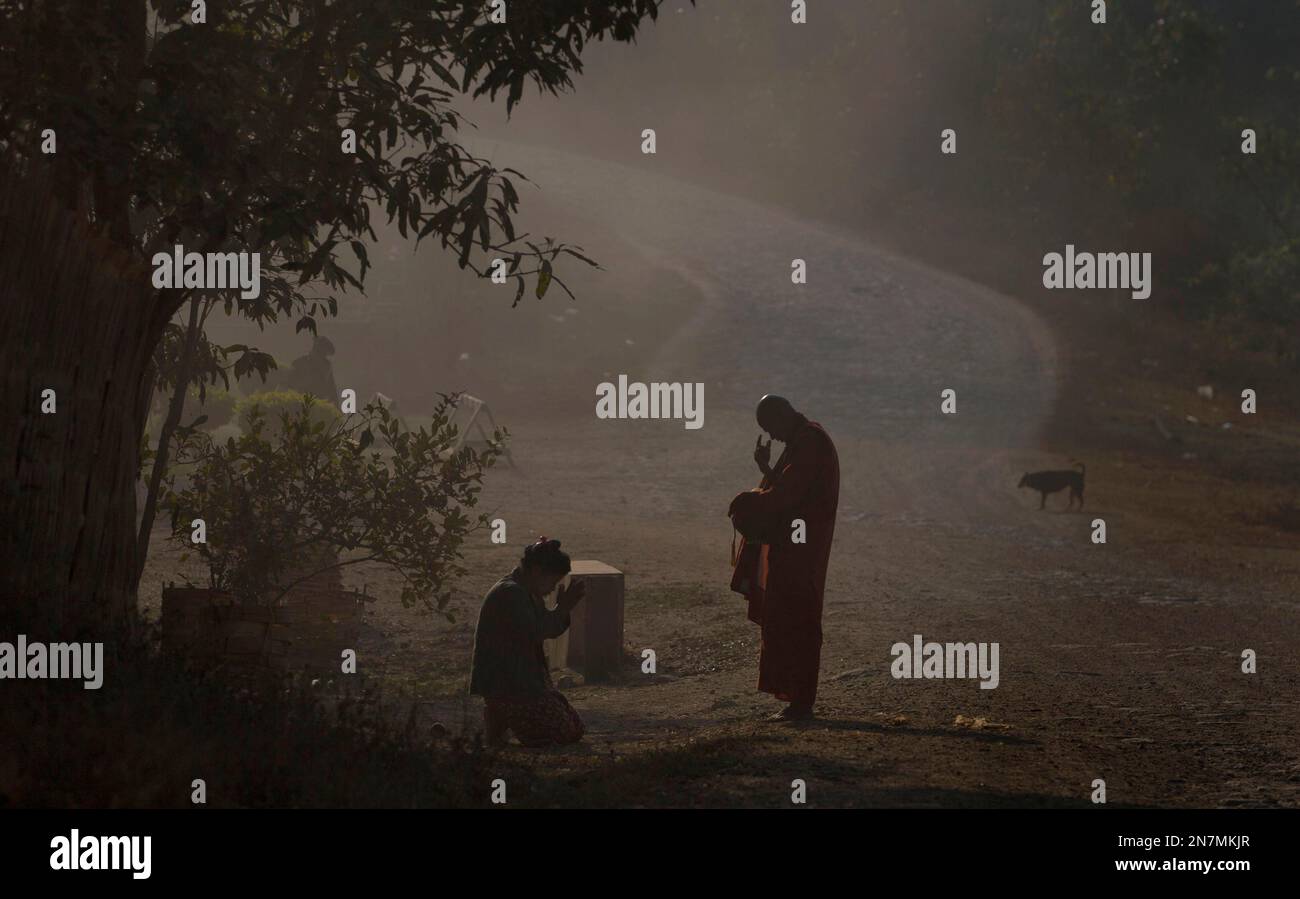 In this Feb. 21, 2013 photo, a devotee prays after offering alms to a ...