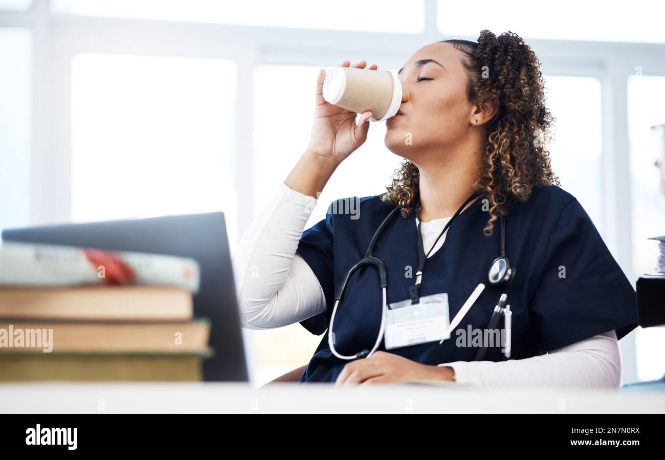 Medical student, technology and drinking coffee in hospital studying ...