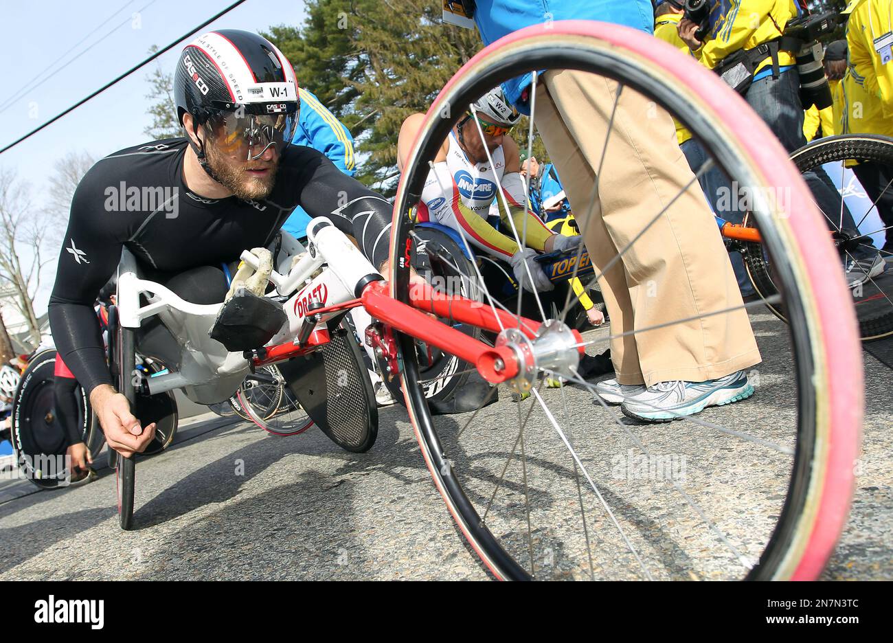 Defending champion Josh Cassidy, of Canada, adjusts his wheelchair ...