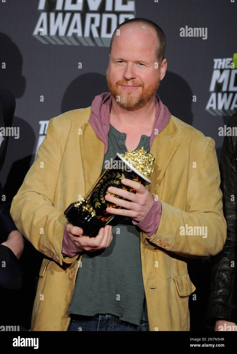 Joss Whedon poses with the award for best fight for "Marvel's The ...