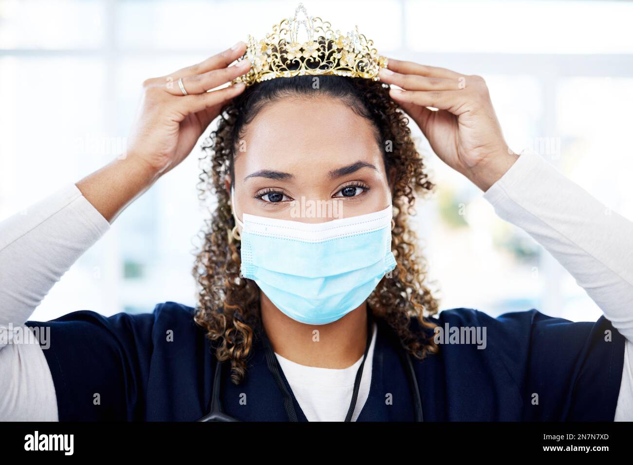 Crown, award and portrait of a doctor with a face mask for celebration ...