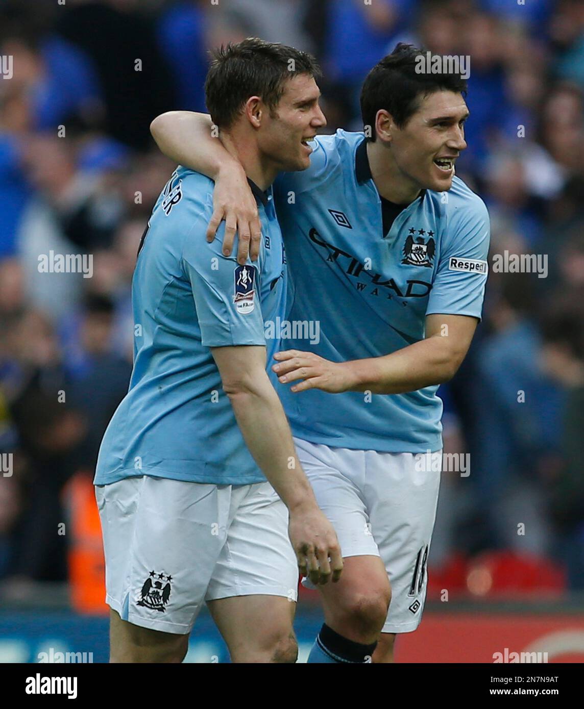 Manchester City's James Milner, left and teammate Gareth Barry hug on ...