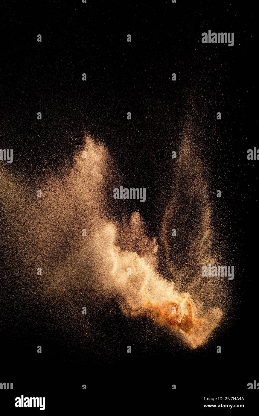 Brown color sand splash against black background. Sand fly wave in the ...