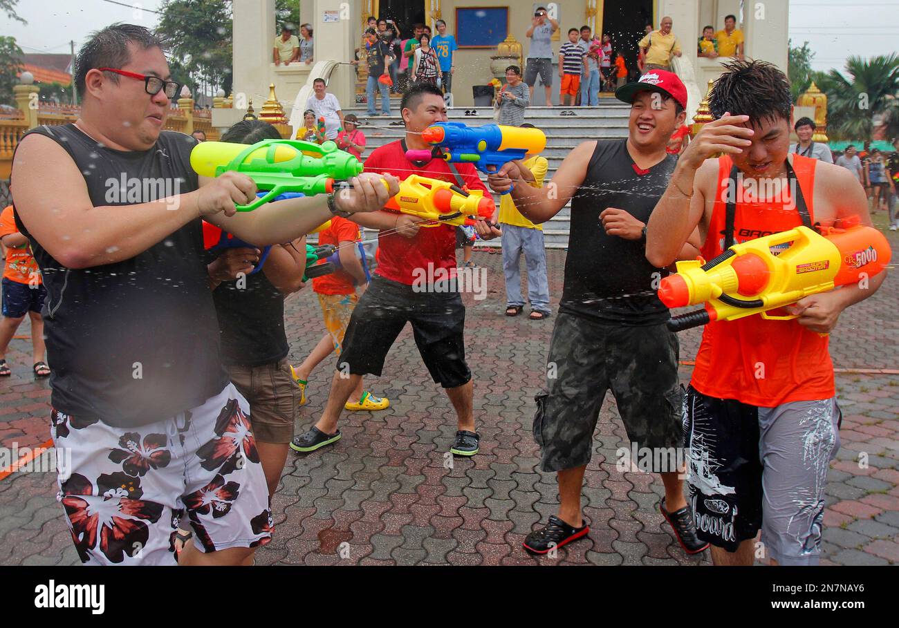 People shoot each other with water guns as they celebrate the Songkran festival, the Thai ...