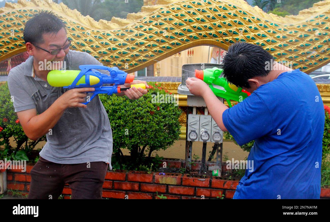 People shoot each other with water guns as they celebrate the Songkran ...