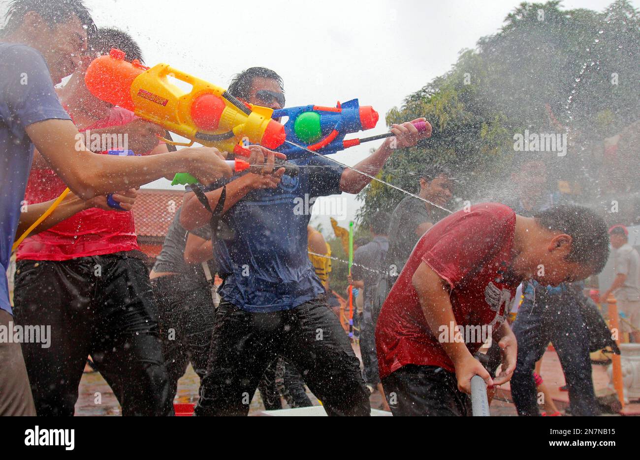 A boy is sprayed with water guns as they celebrate the Songkran festival, the Thai traditional ...