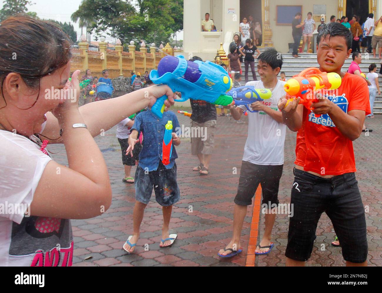 People shoot each other with water guns as they celebrate the Songkran ...
