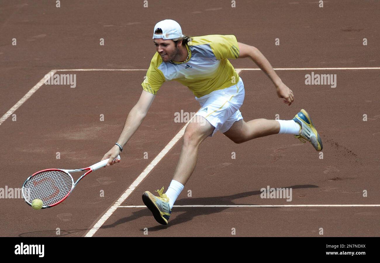 Rhyne Williams, of the United States, returns a shot to Nicolas Almagro ...