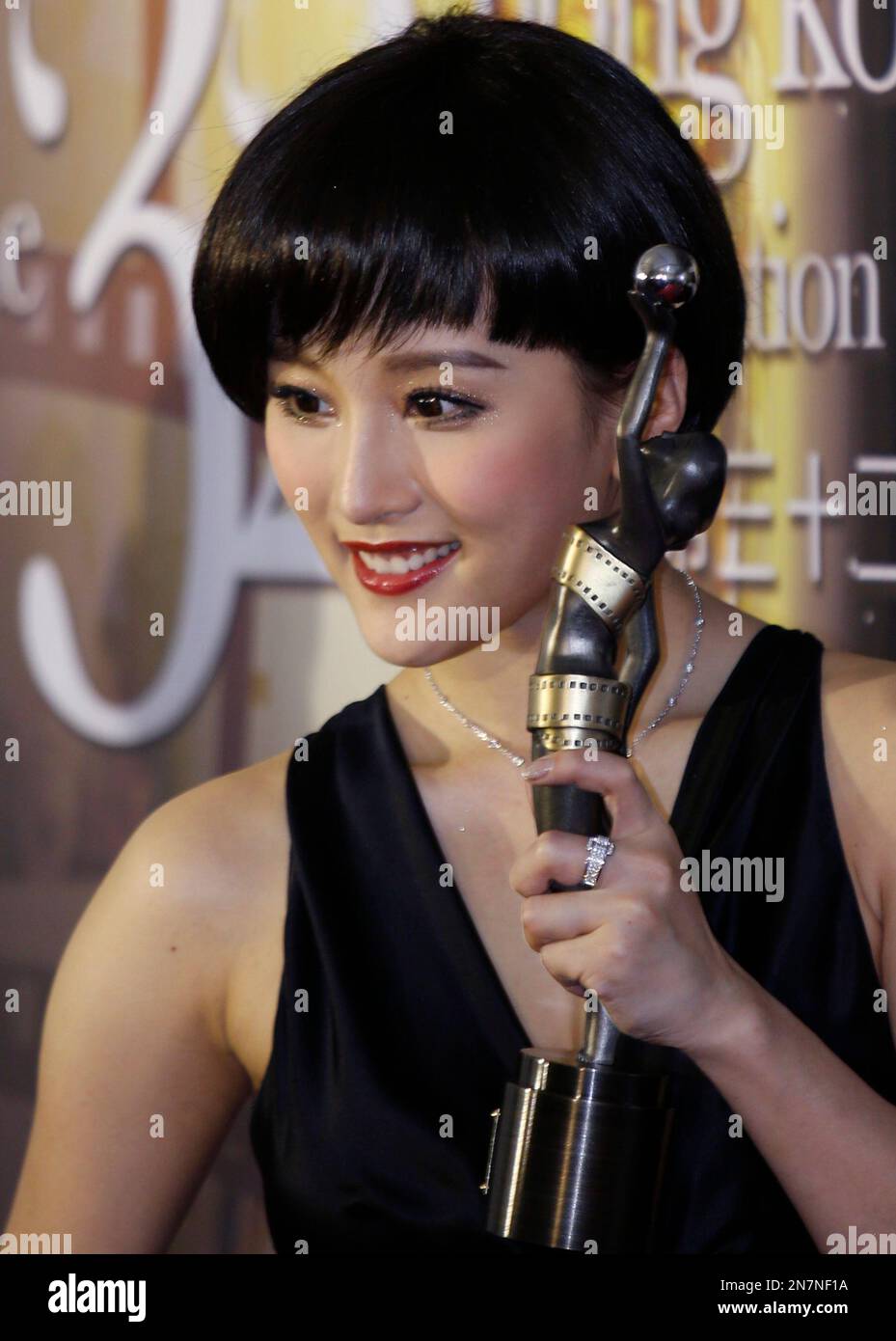 Hong Kong actress Dada Chan poses for photographers after winning the ...