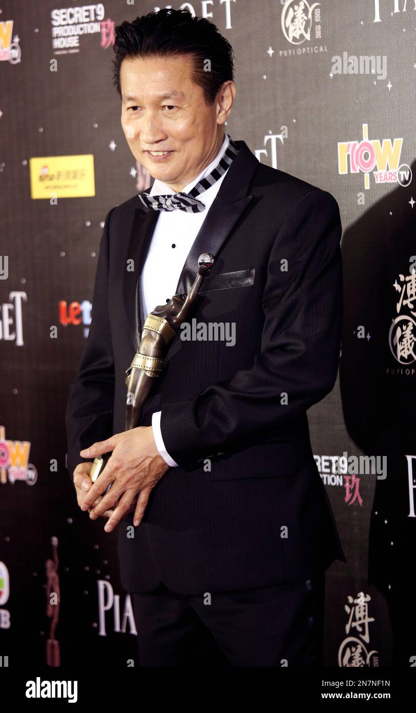 Hong Kong actor Alex Tsui poses after winning the Best New Performer award for his her role in ...