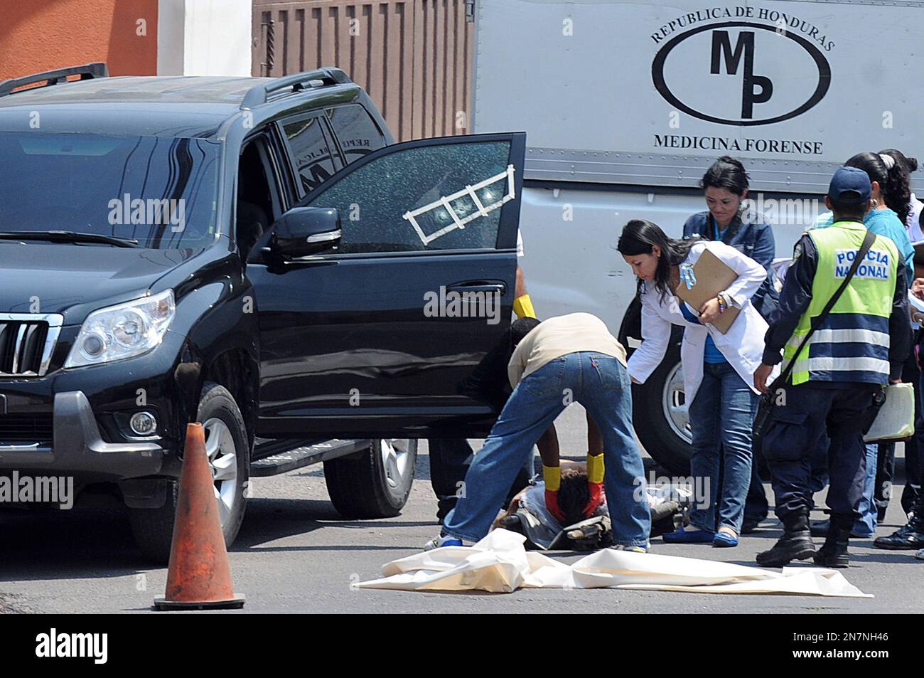 A forensic team inspects the body of businessman Raul Laitano Andino ...