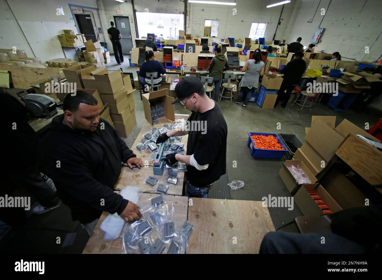 Workers package rifle magazines for AR-15 rifles at Ammunition Storage ...