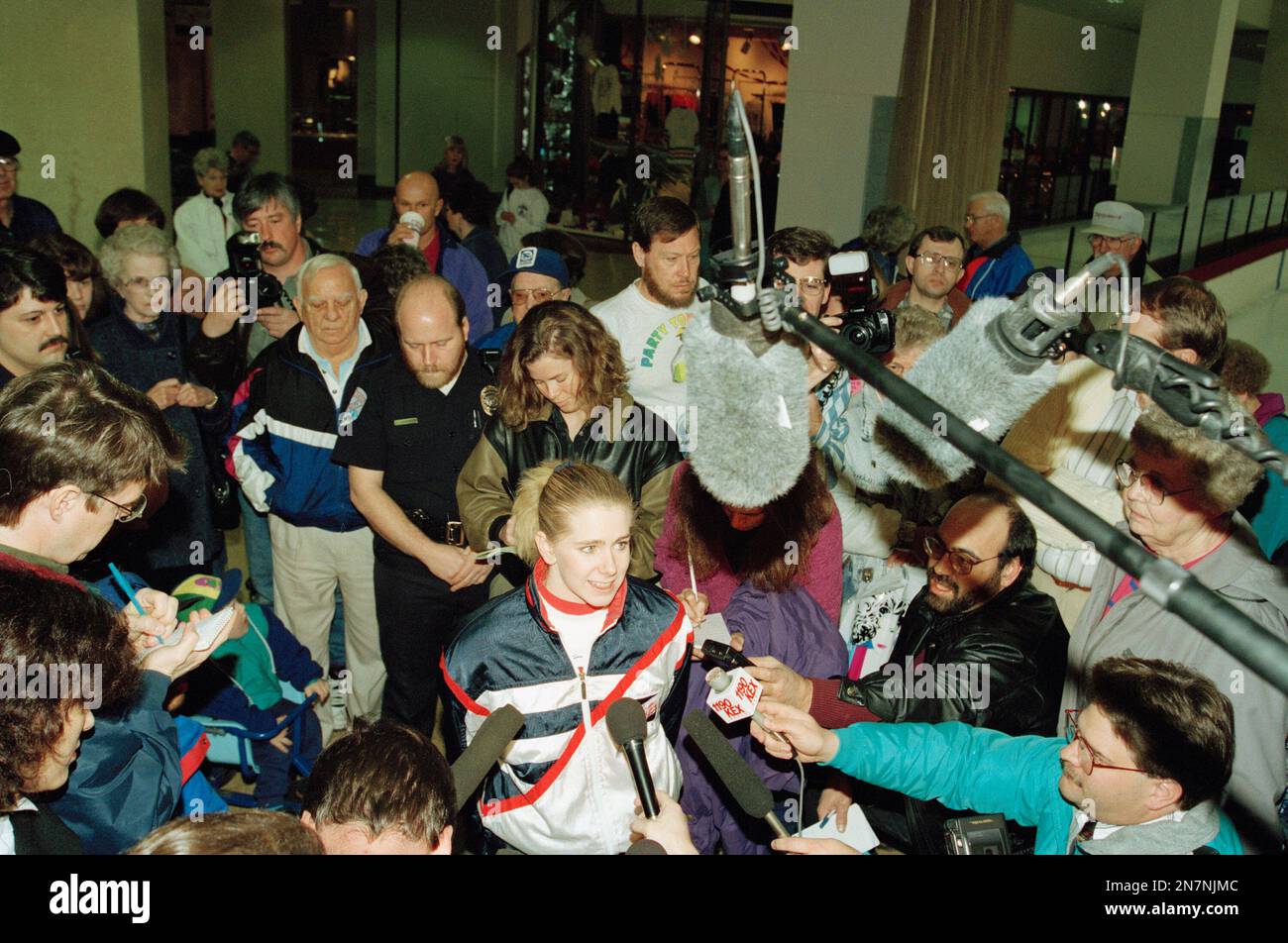 Figure skater Tonya Harding is surrounded by media as she leaves a ...