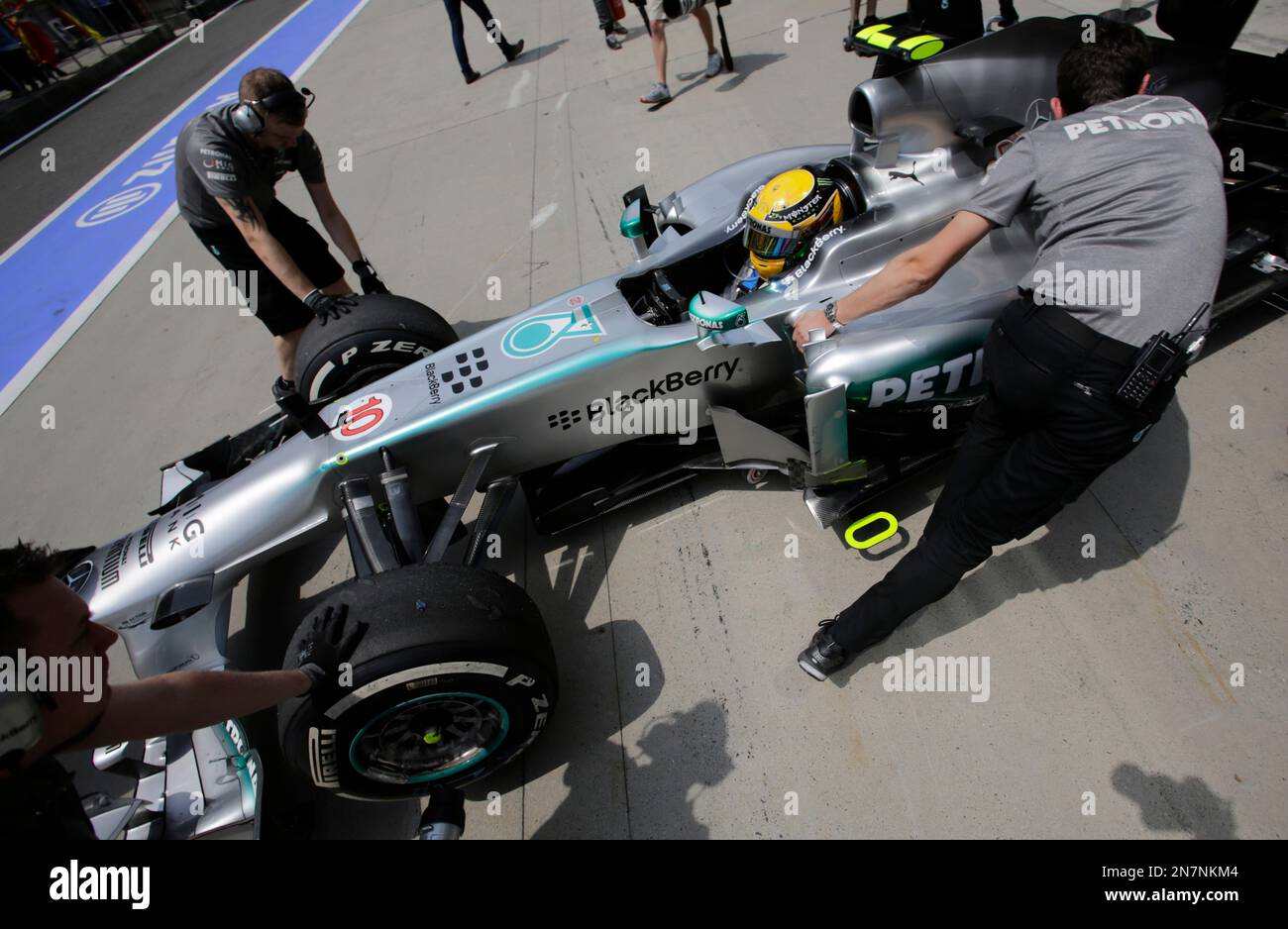 Crews push the car of Mercedes driver Lewis Hamilton of Britain has his ...