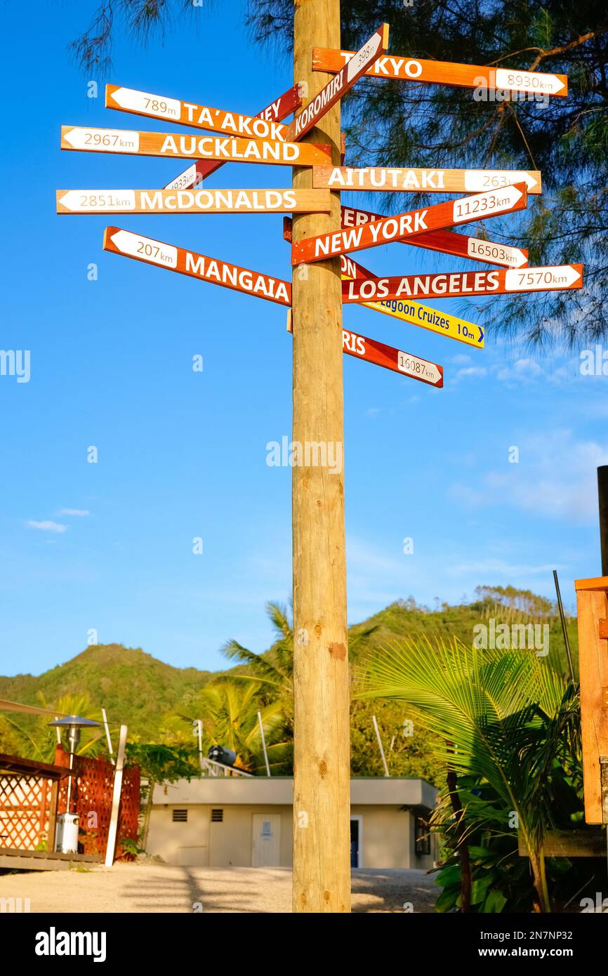 Tall sign post pointing directions to cities and towns around Cook ...