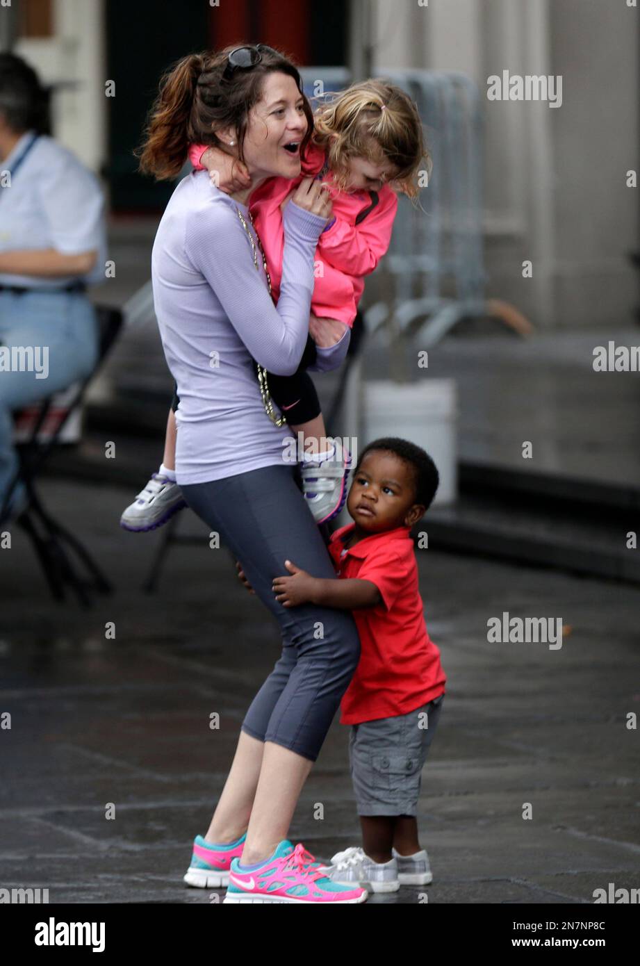 Kyron Dowden, 16 months, of Slidell, La., hugs the legs of Mary Munson ...