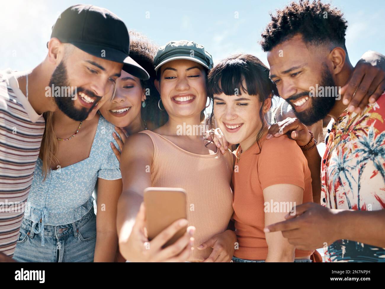 A selfie for social media. a diverse group of friends standing together ...