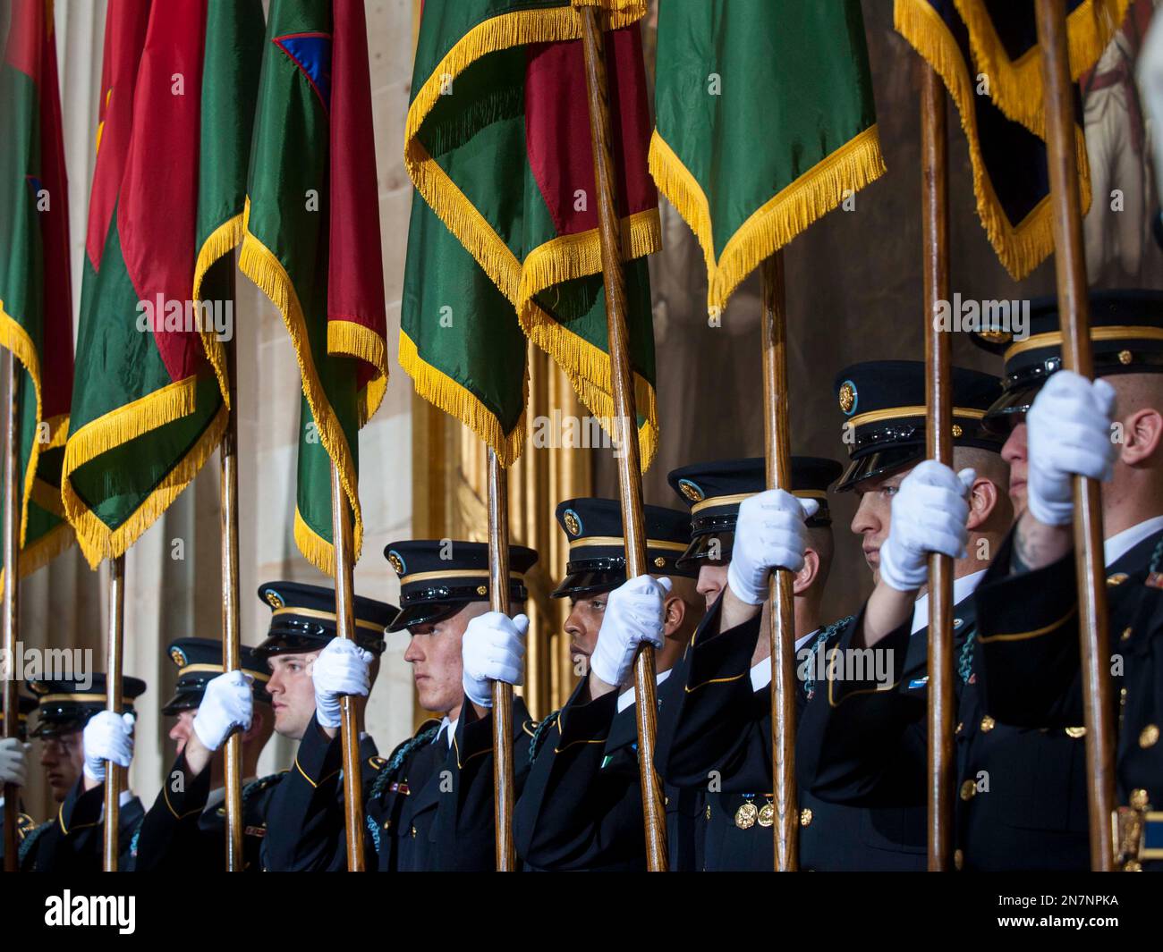 Honor guard members carry the flags of the military divisions that ...