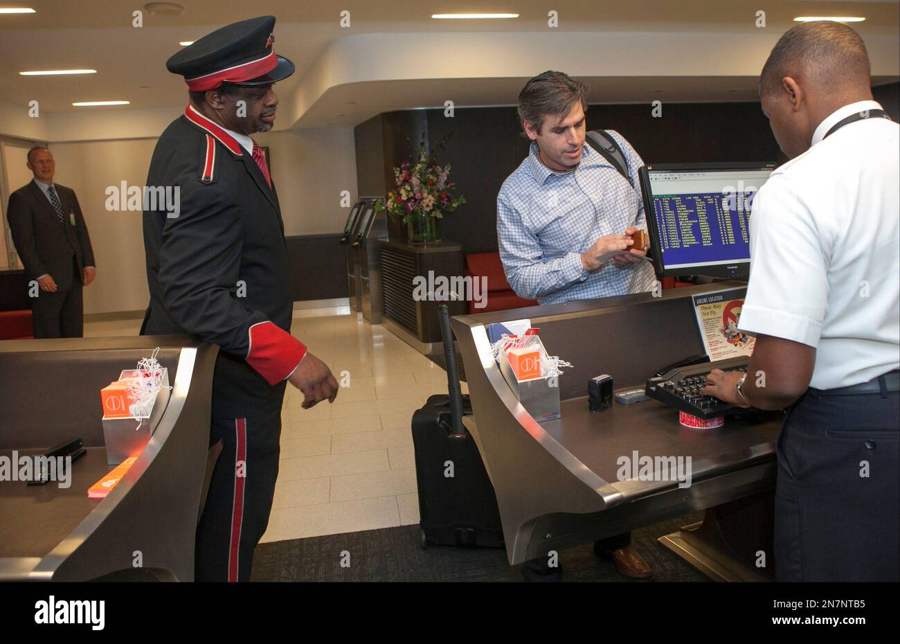 In this Thursday, March 14, 2013 photo, American Airlines skycaps Alex ...