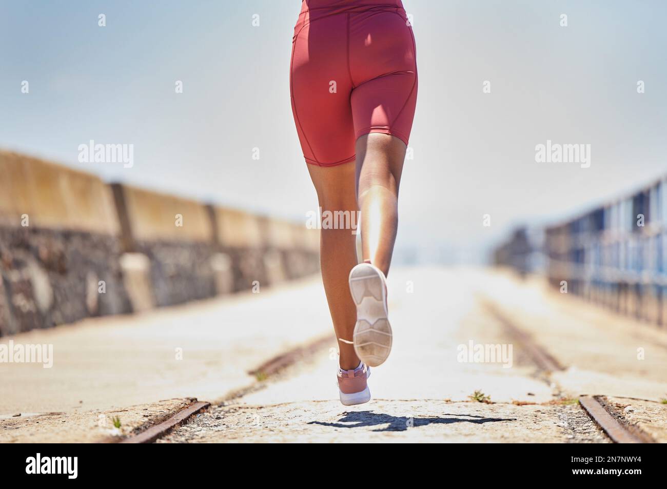 Legs, running and fitness with runner outdoor, black woman athlete with ...