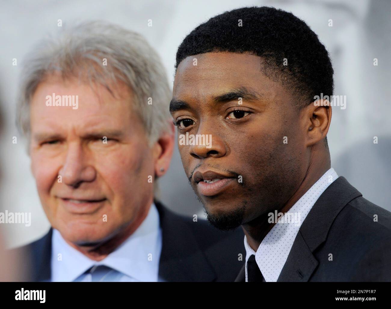 Chadwick Boseman, right, and Harrison Ford, cast members in "42," pose ...