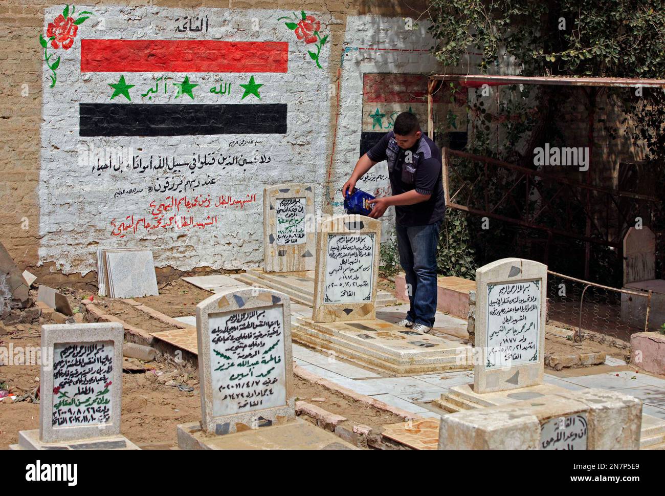 In this Saturday, April 6, 2013 photo, an Iraqi man pours water onto ...