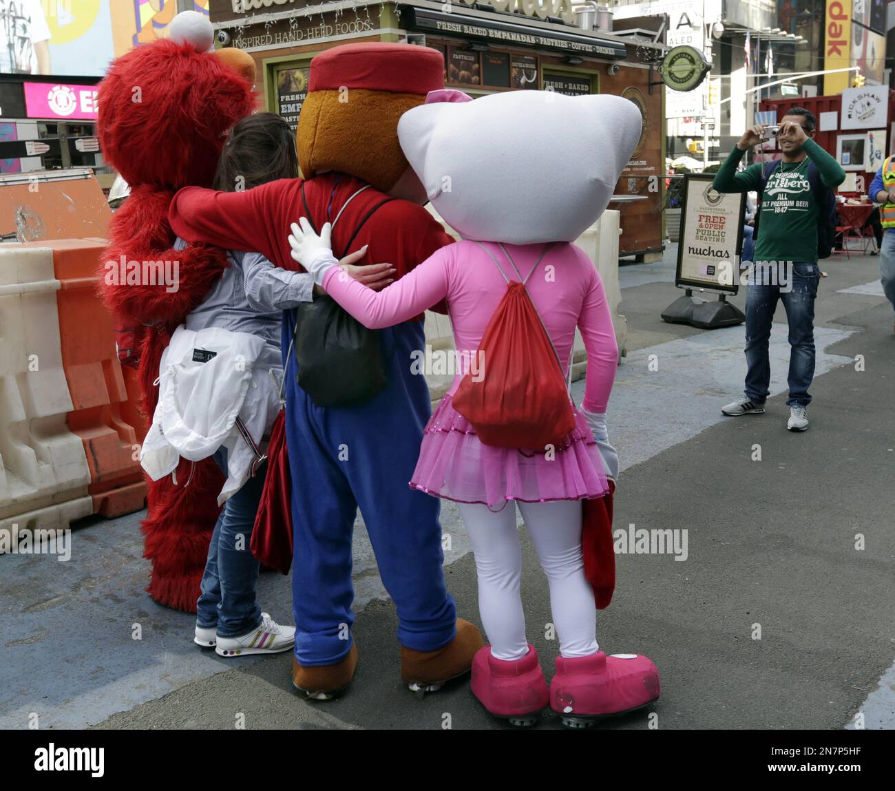 Elmo, Super Mario, and Hello Kitty characters pose for photo, in New ...