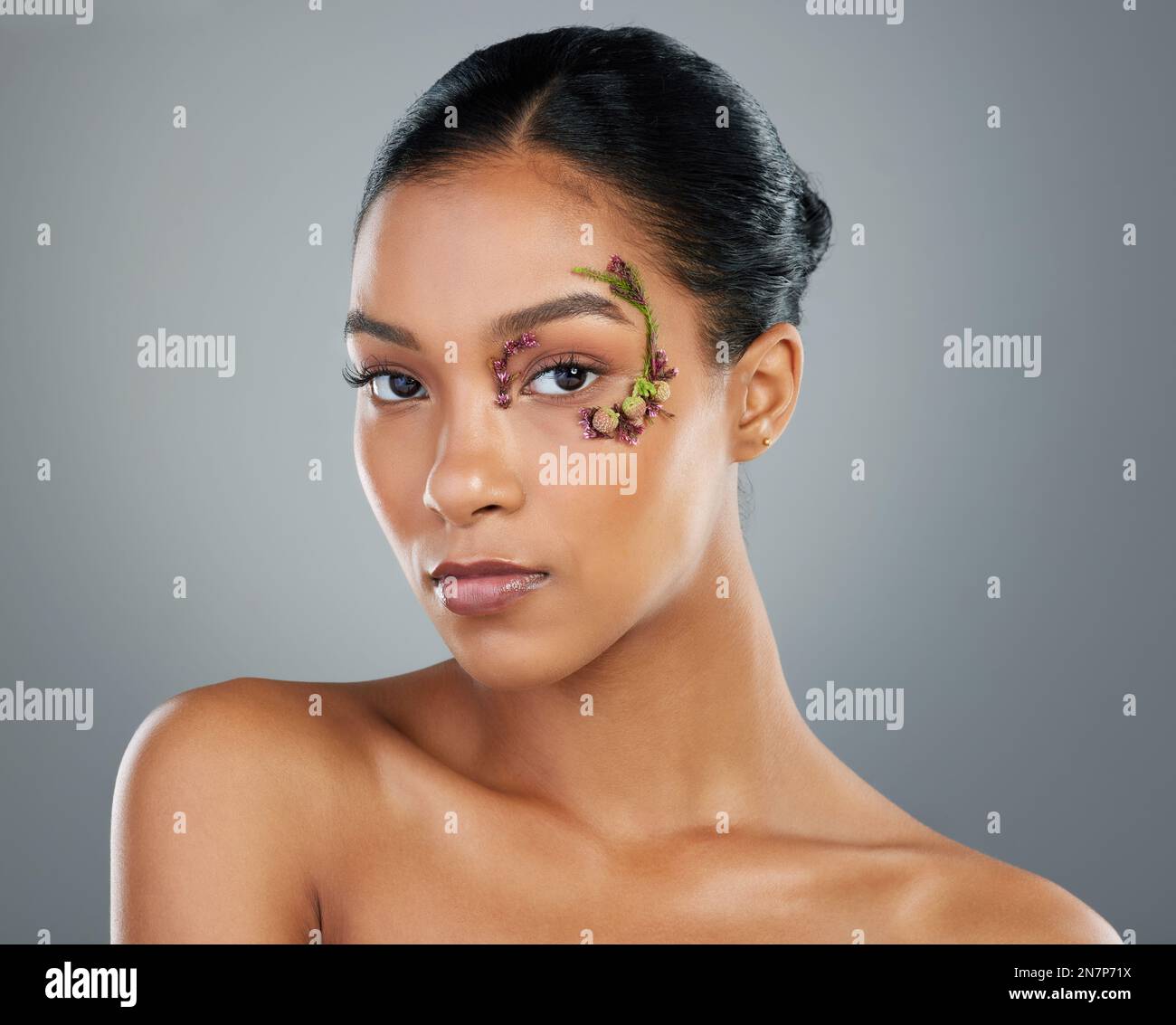 Pretty like a flower. a beautiful young woman posing with flowers on ...