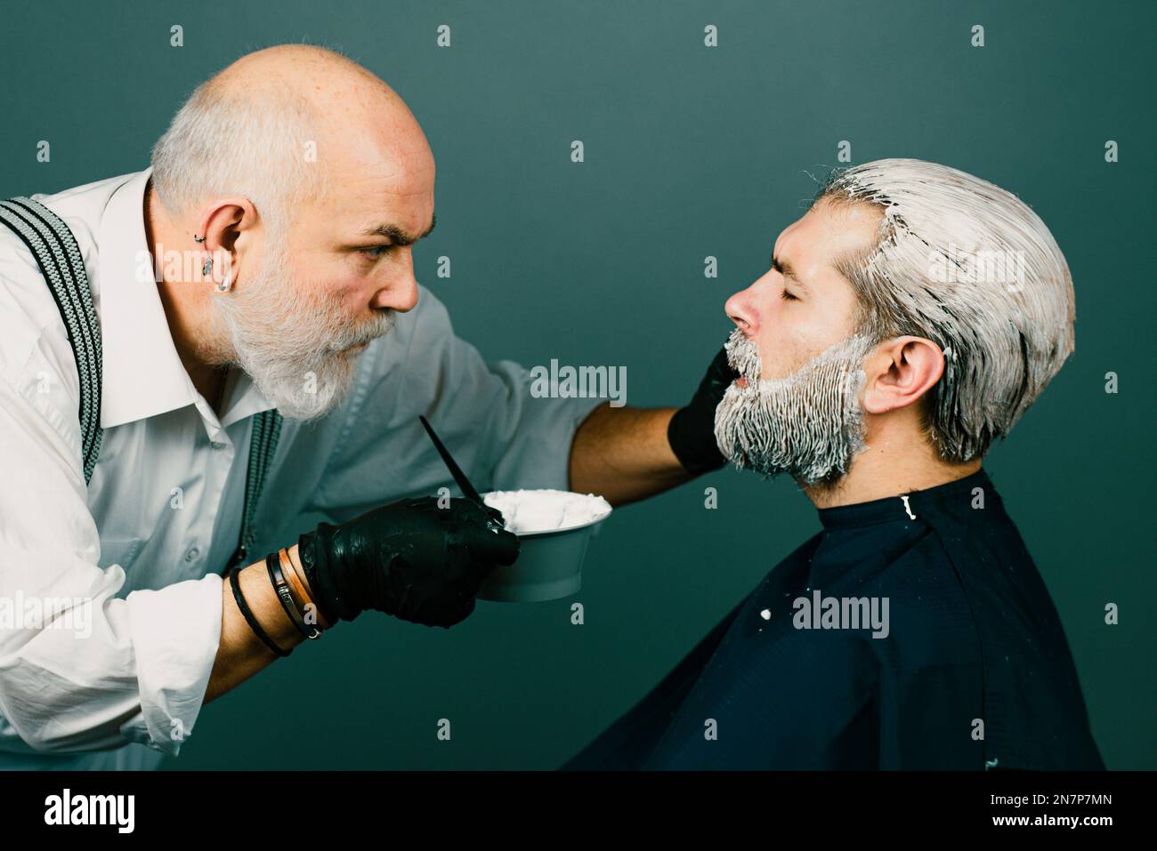 Process of dyeing hair for man at beauty salon, male closeup portrait ...
